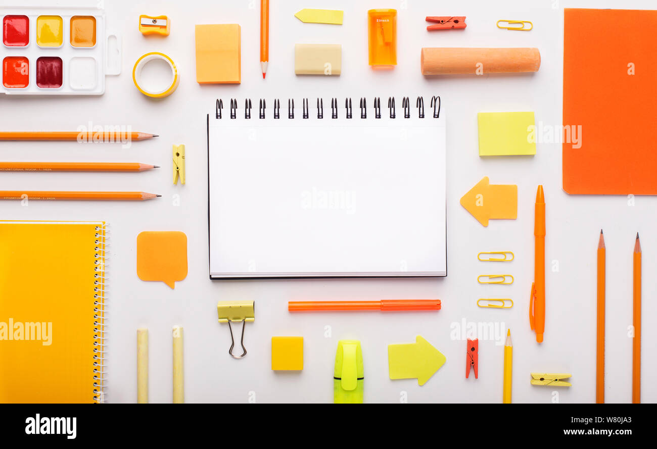 Orange colored office stationery and notepad on white Stock Photo - Alamy