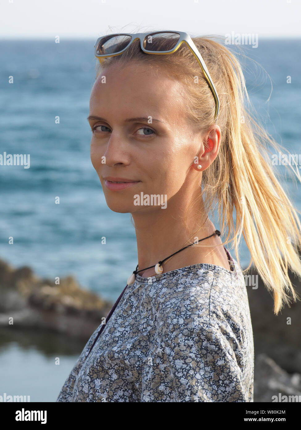 Portrait woman posing during sunset on the background of the Atlantic ...
