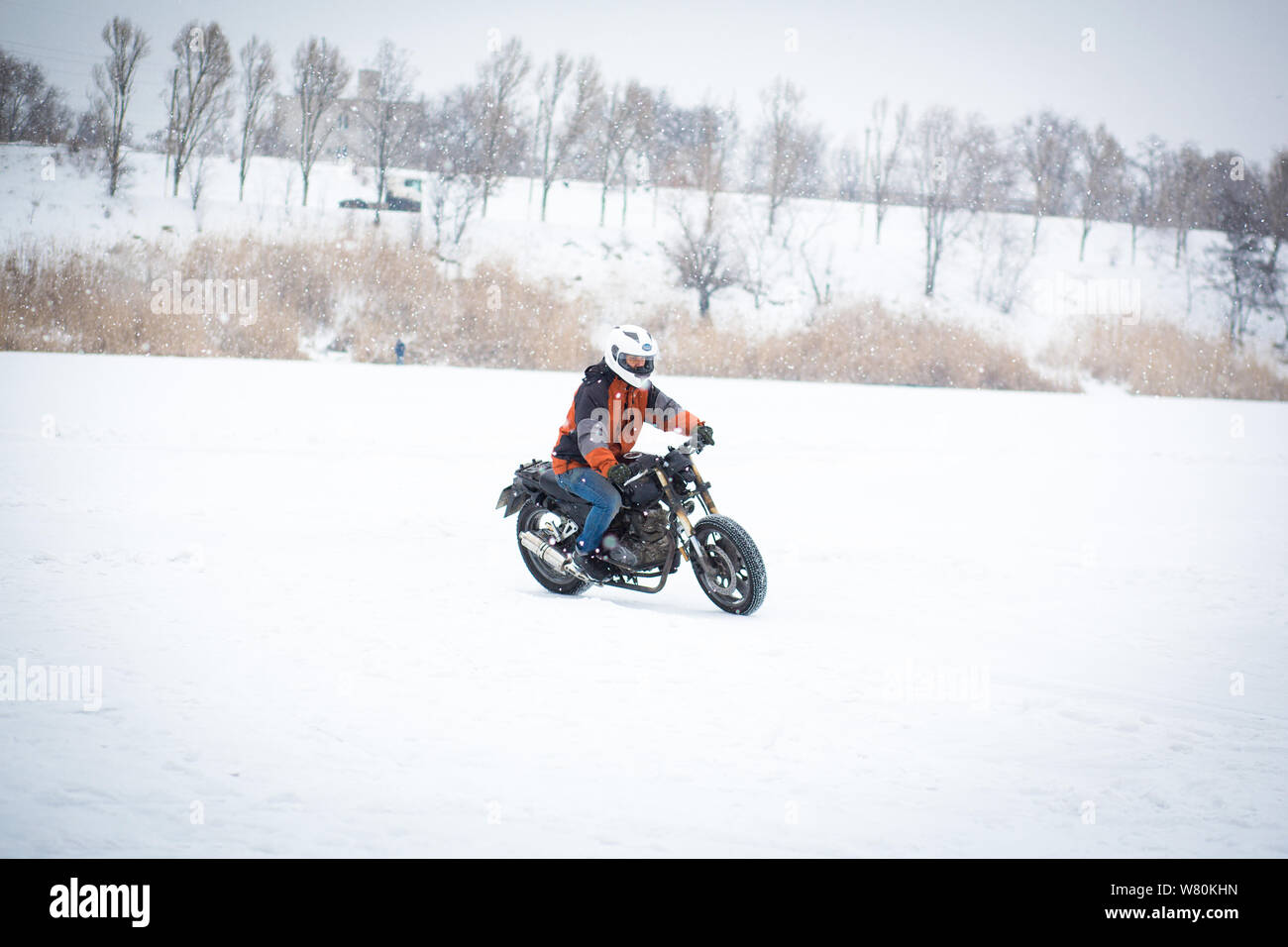 A guy rides a motorcycle on a frozen lake Stock Photo - Alamy