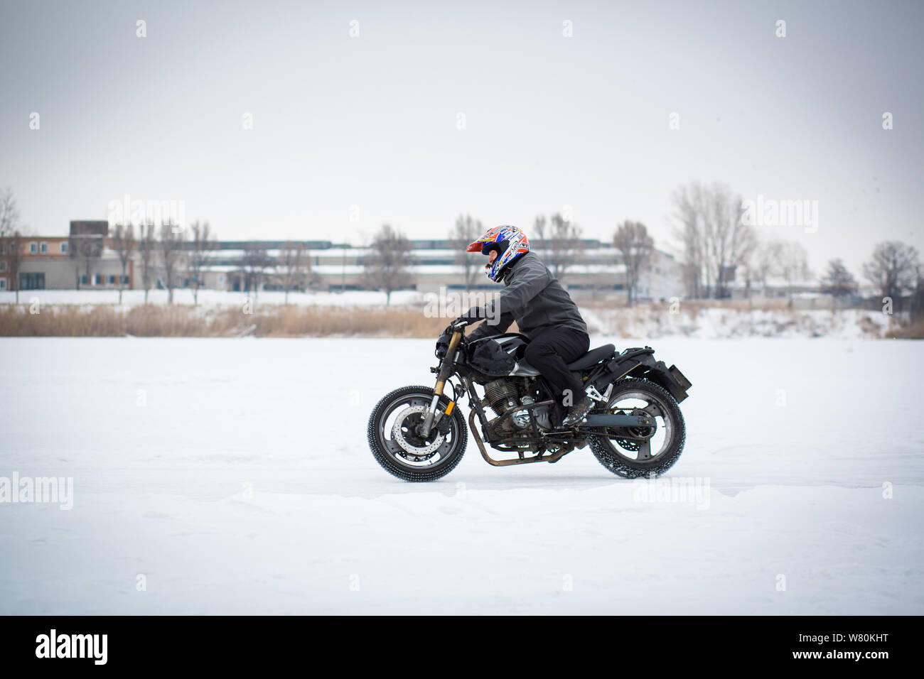A guy rides a motorcycle on a frozen lake Stock Photo - Alamy