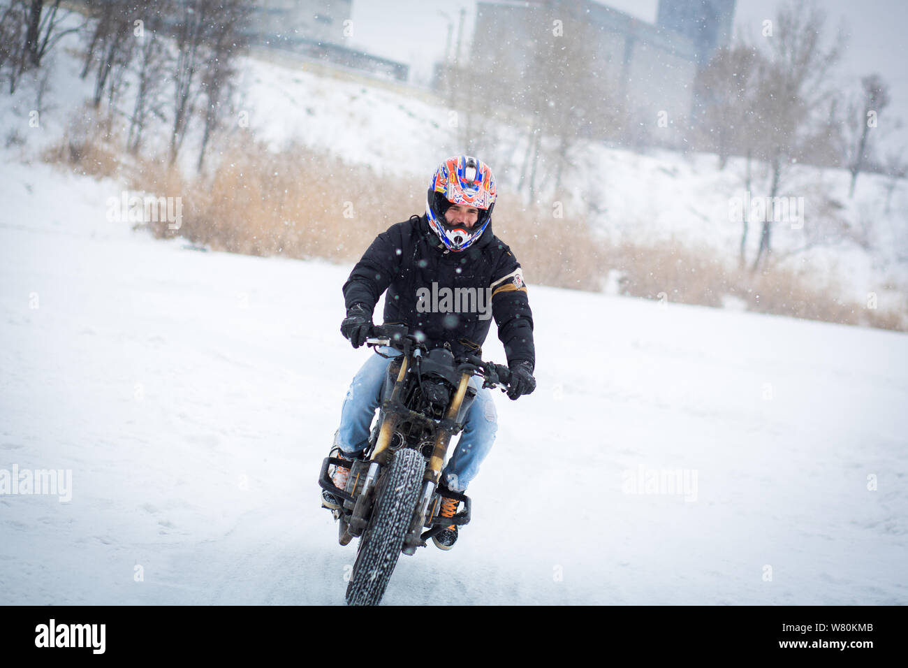 A guy rides a motorcycle on a frozen lake Stock Photo - Alamy