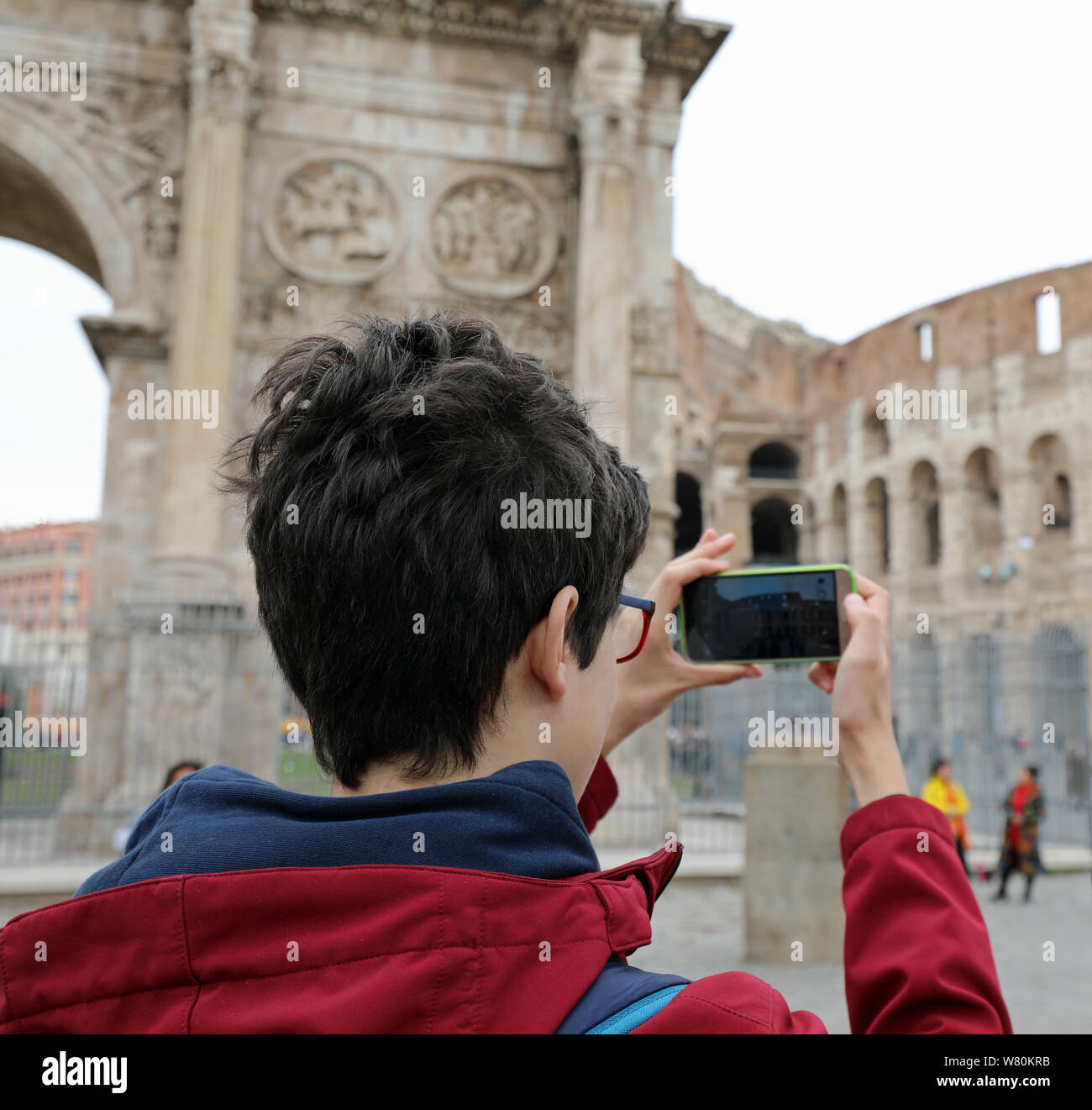 boy photographs the Colosseum in Rome with his mobile phone Stock Photo ...