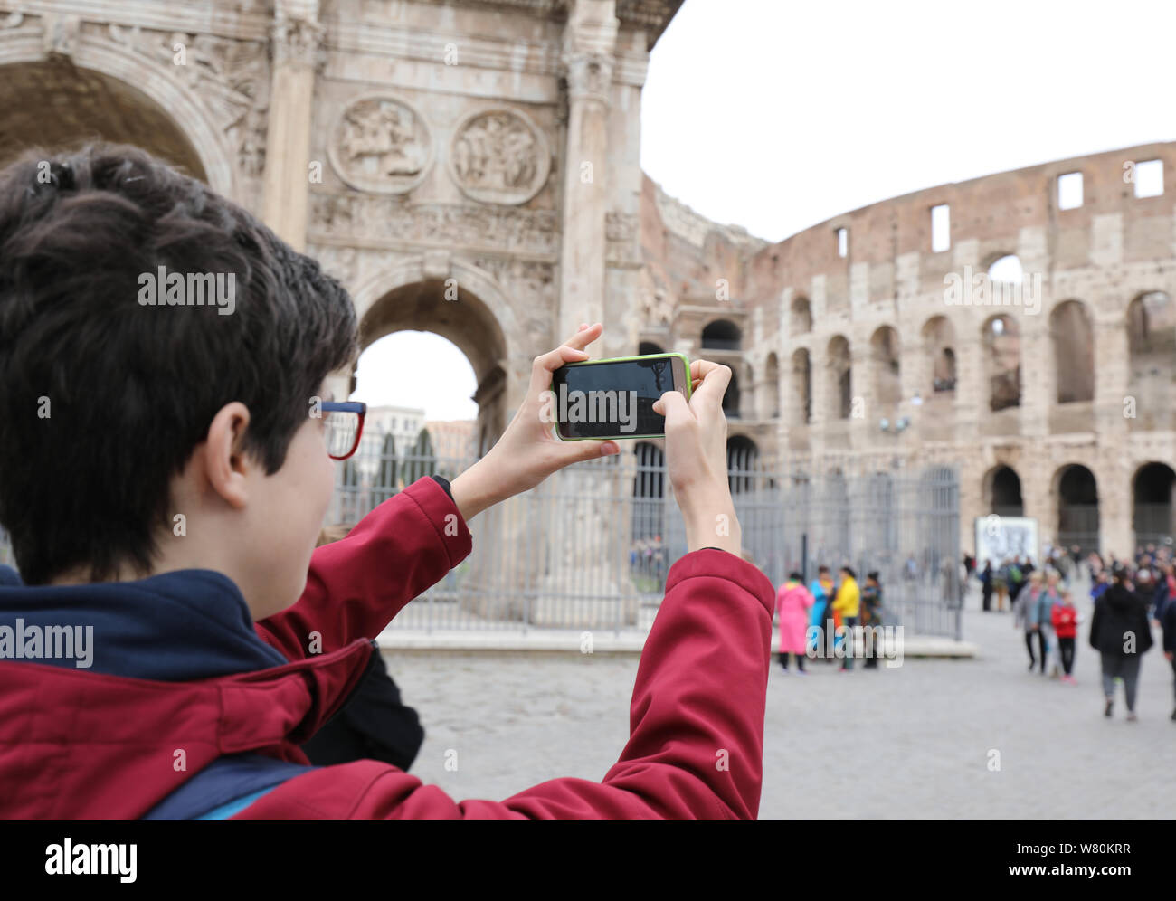 boy photographs the Colosseum in Rome with his cell phone Stock Photo ...