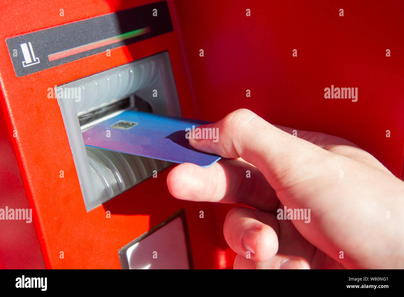 Hand of a man with a credit card, using an ATM. Man using an atm ...