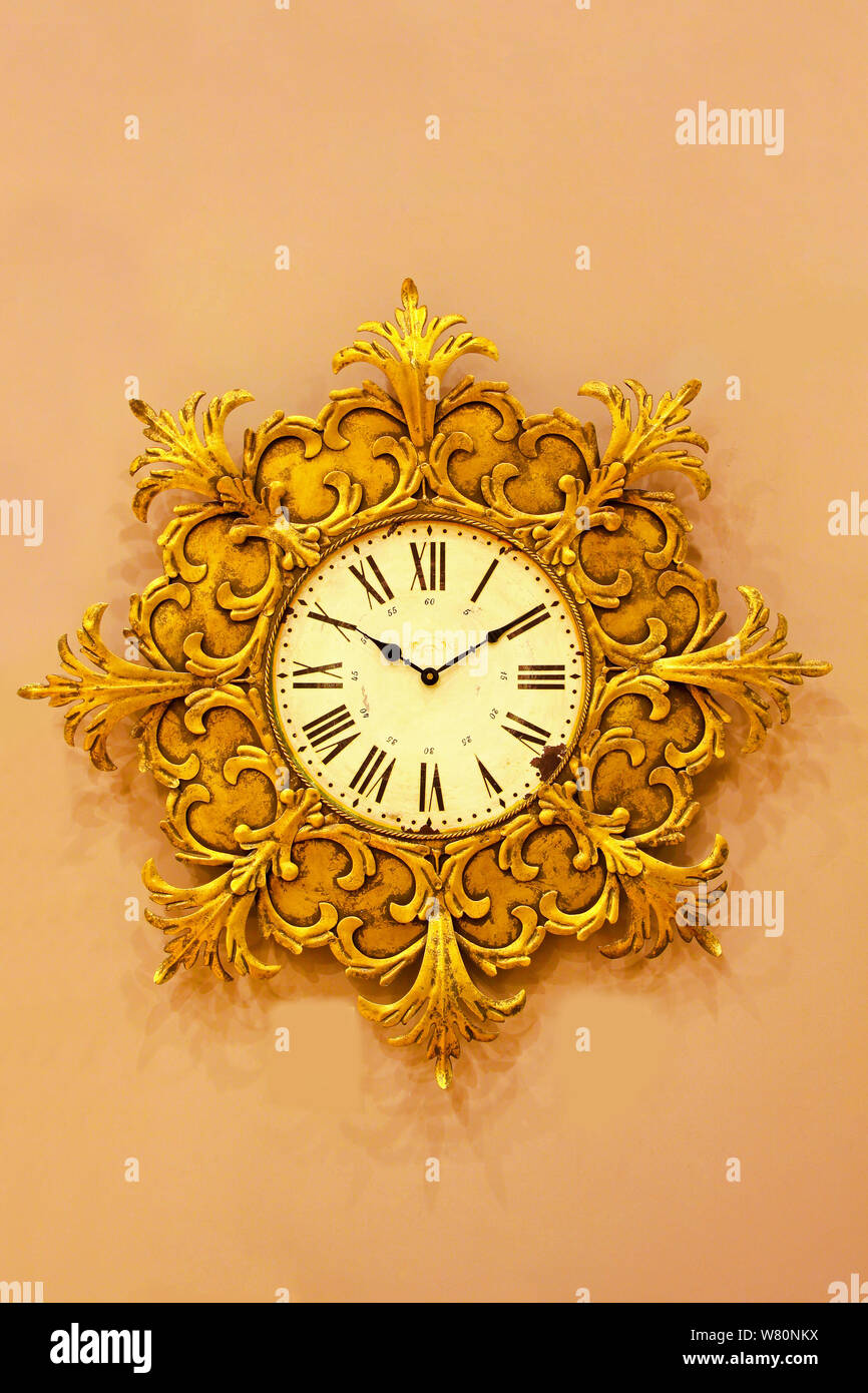 Antique clock with decorative frame on the wall Stock Photo - Alamy