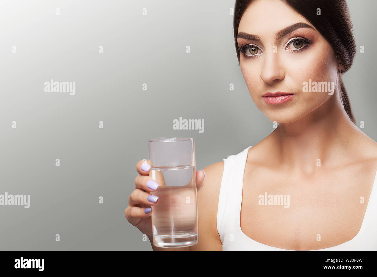 Drink water. Young girl drinking water from the glass. Daily water ...