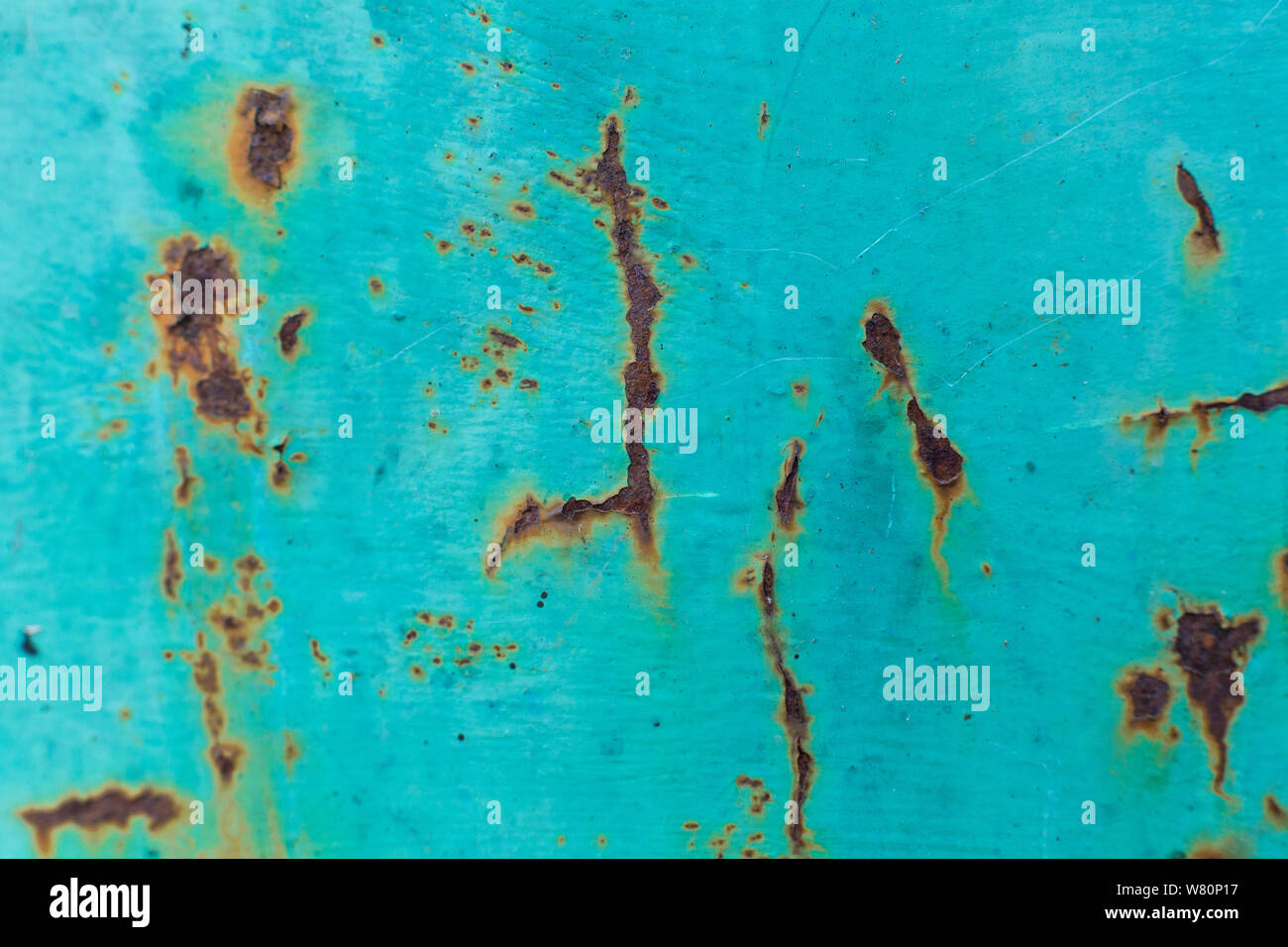 Rust appears through paint on metal doors Stock Photo - Alamy