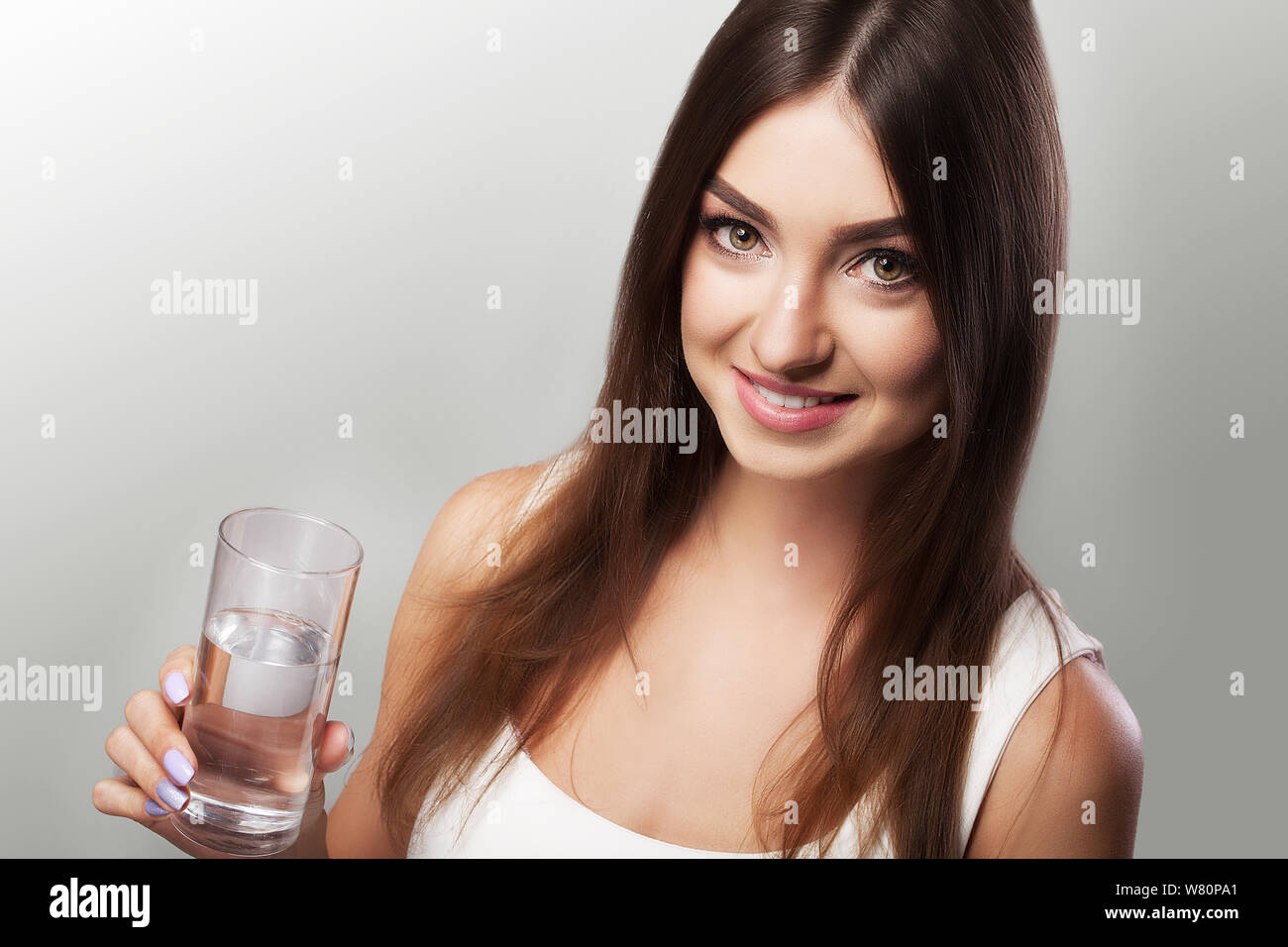 Drink water. Young girl drinking water from the glass. Daily water ...