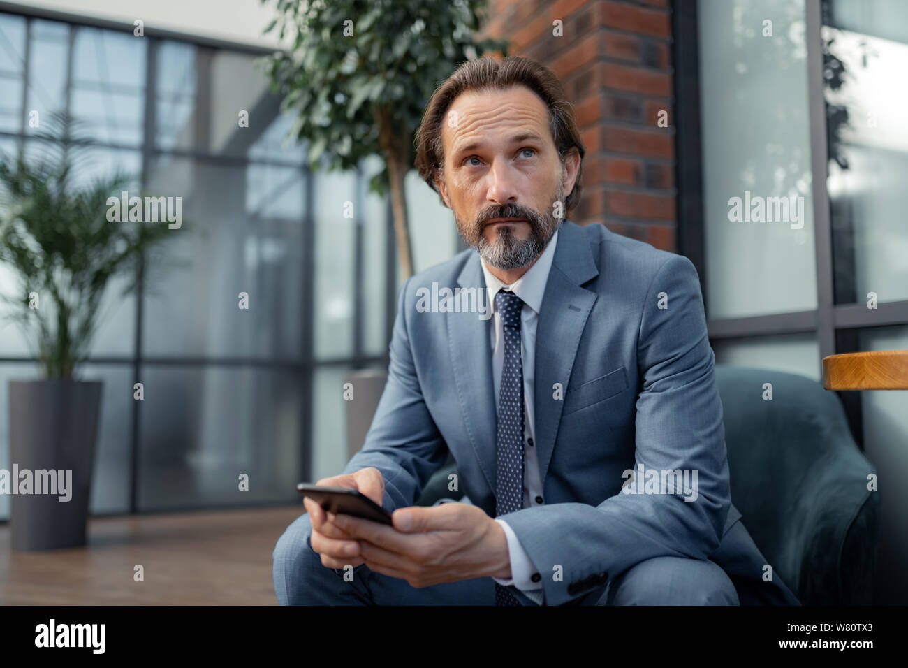 Businessman feeling thoughtful while waiting for the meeting Stock ...