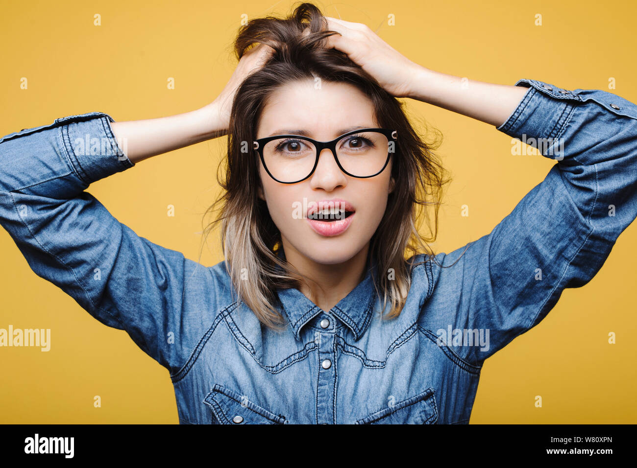 Portrait of a beautiful girl holding her hair being amazed , dressed in ...
