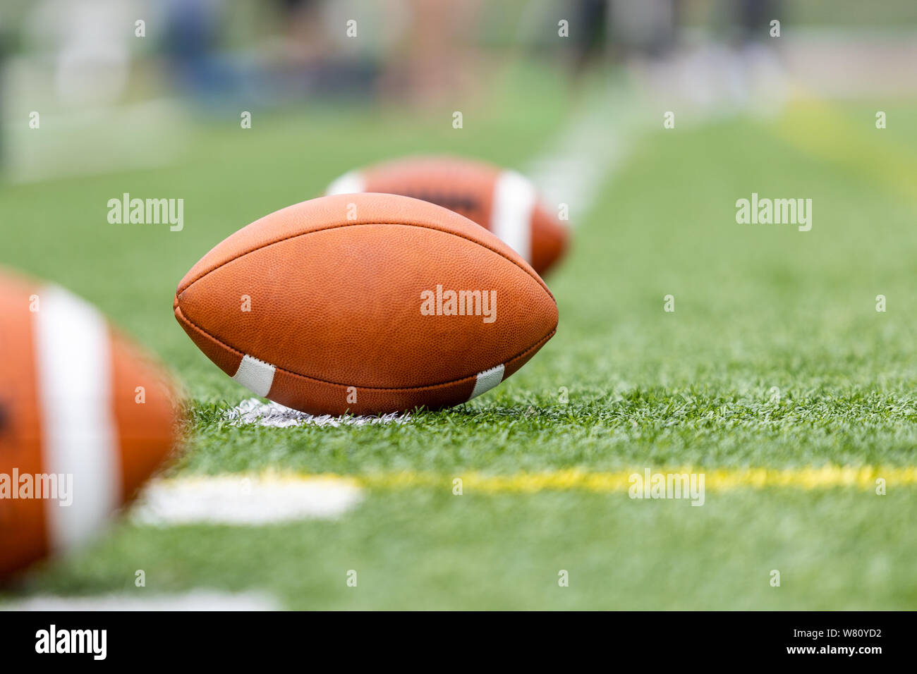 Three football balls on a laying on a green field Stock Photo - Alamy