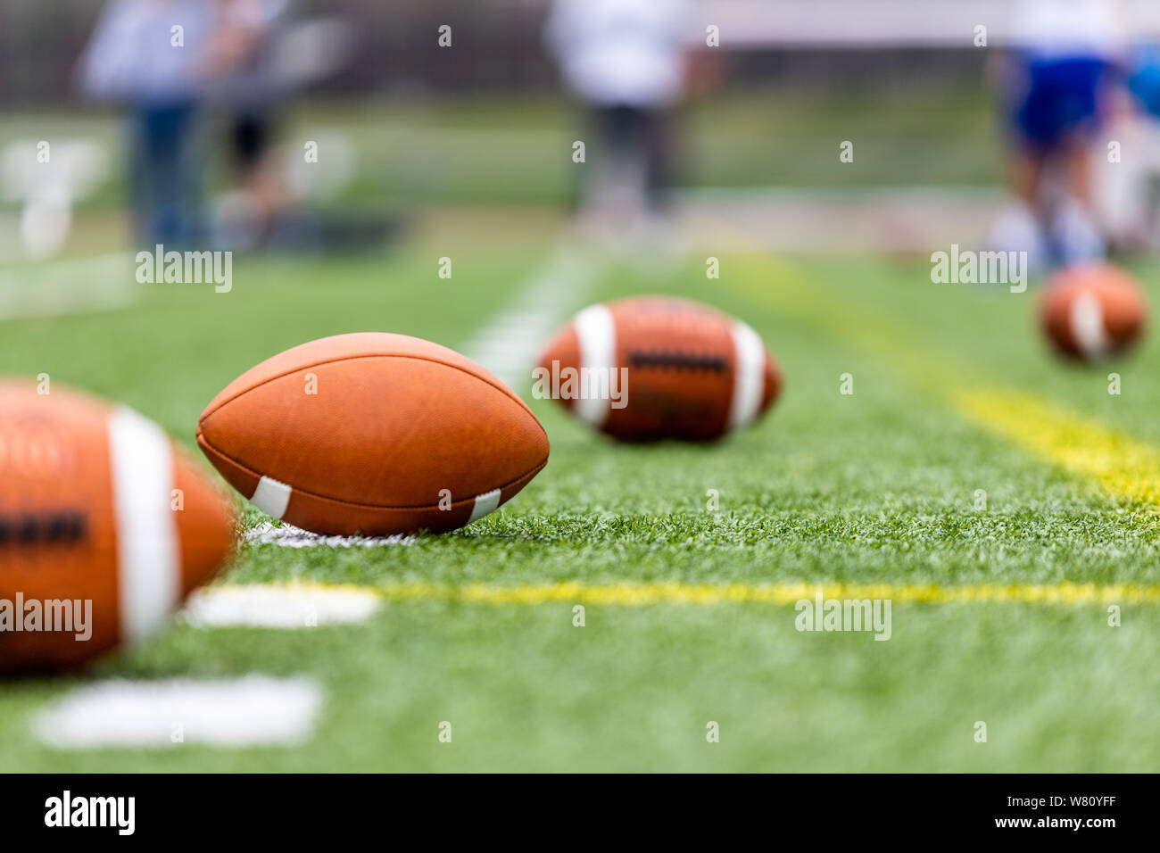 Multiple football balls are laying on a training field Stock Photo - Alamy