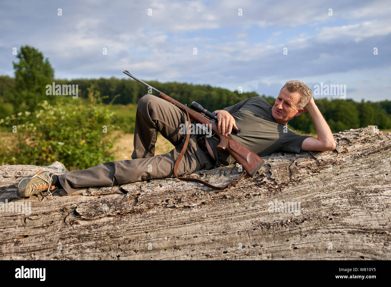 Hunter with rifle in the forest Stock Photo - Alamy