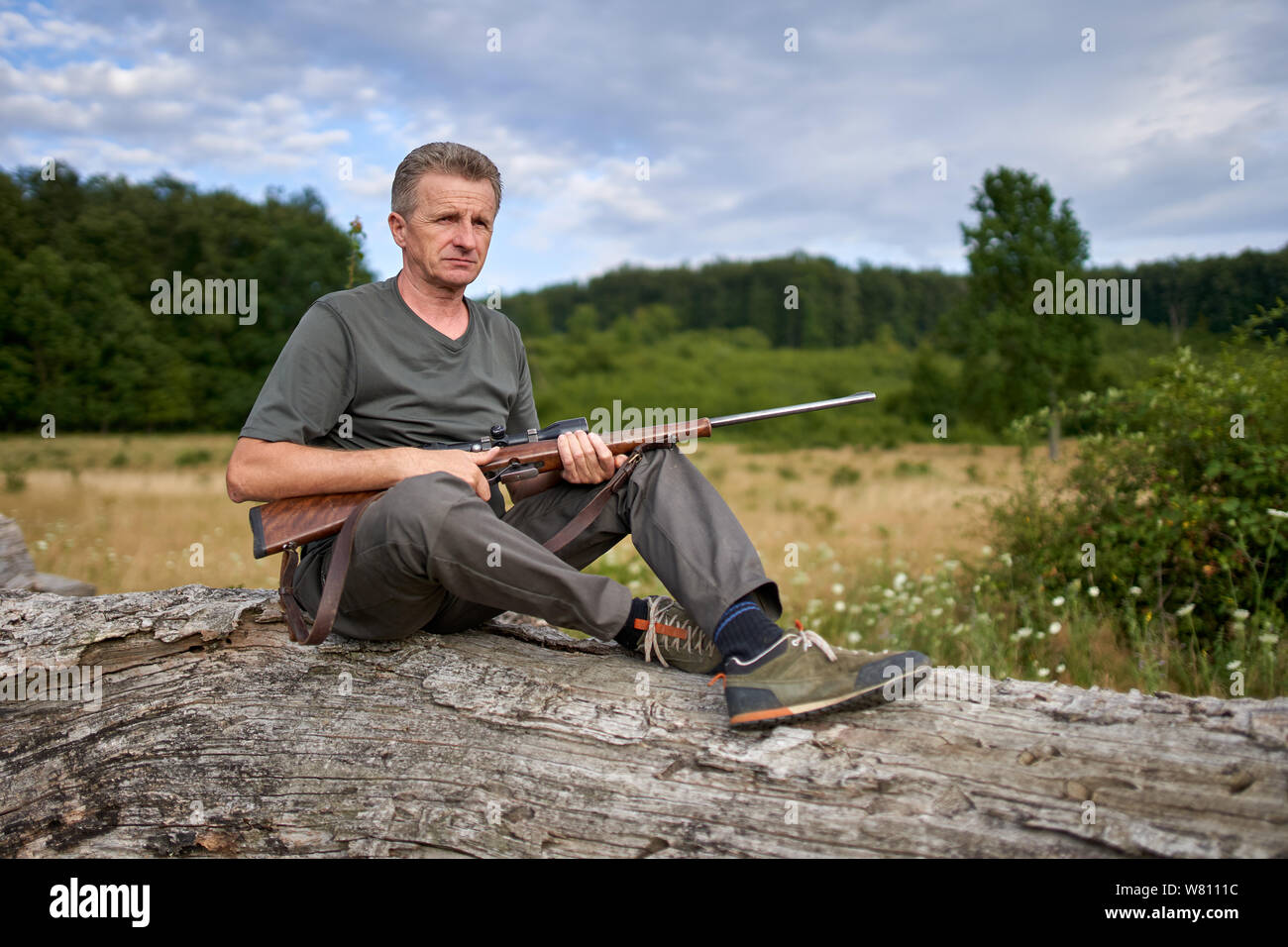 Hunter with rifle in the forest Stock Photo - Alamy