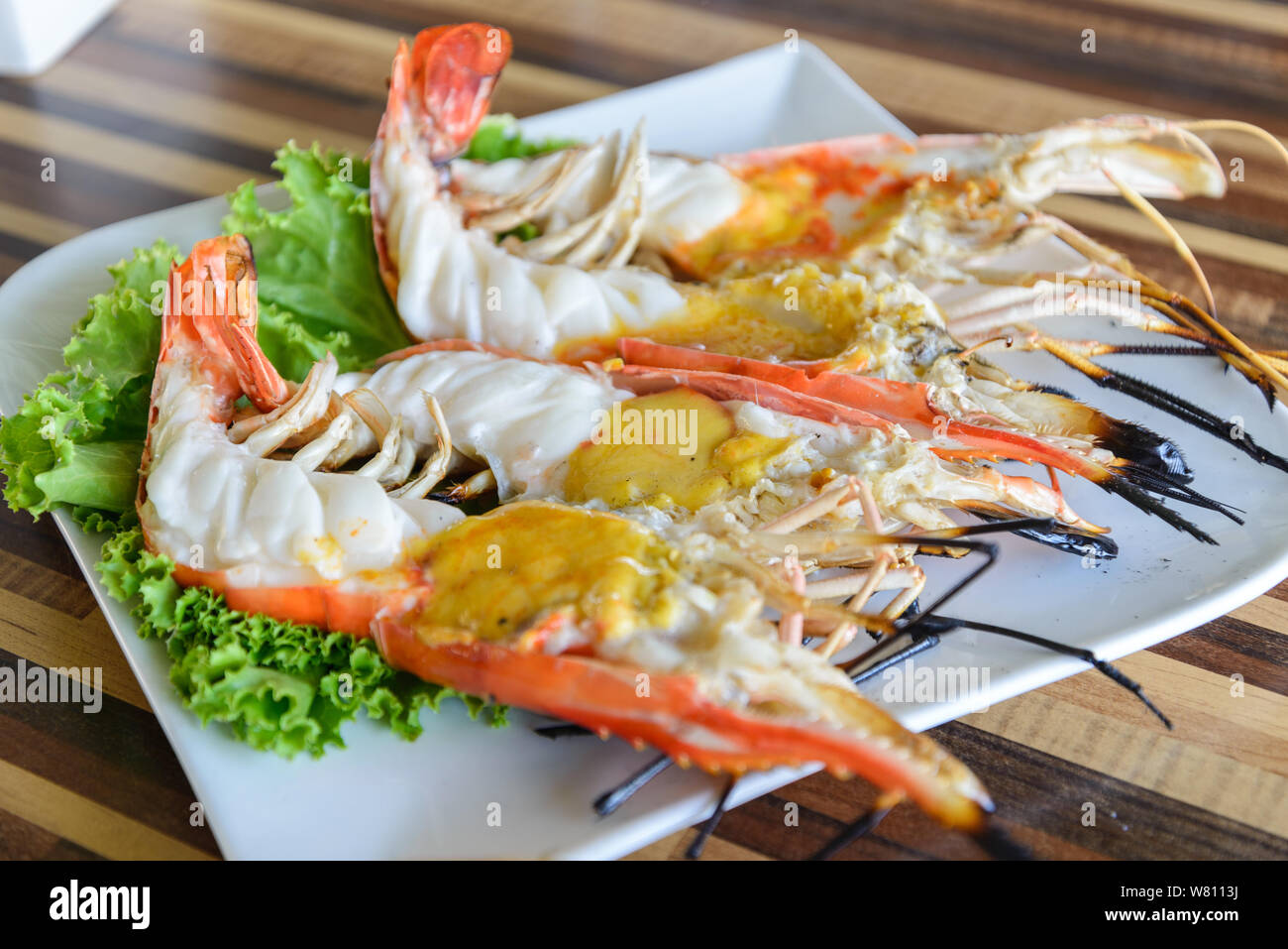 Cutting half grilled giant river prawn, famous local Thai luxury fine ...