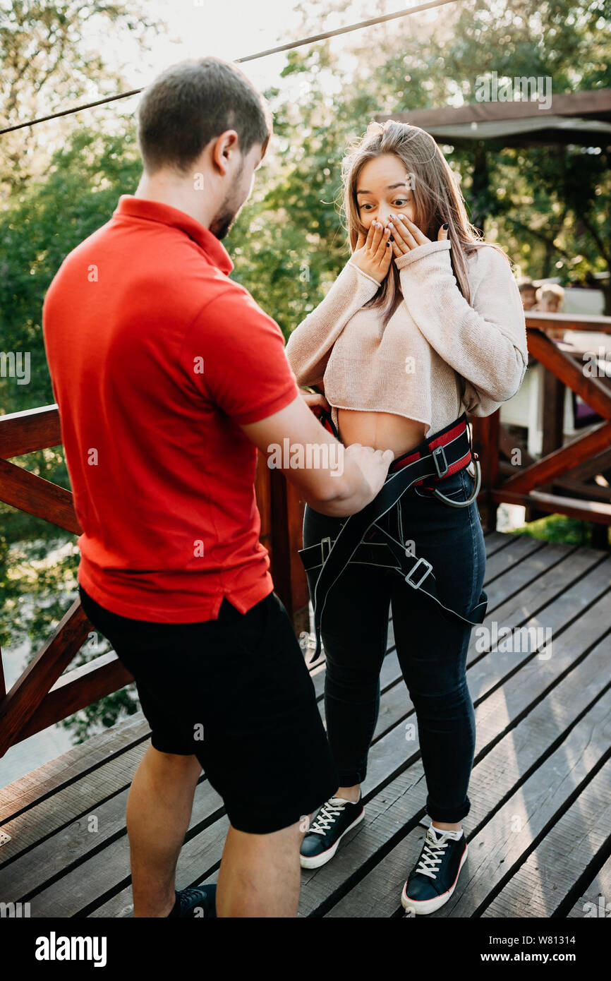 Lovely caucasian woman being scared while equipped by a rope slide ...