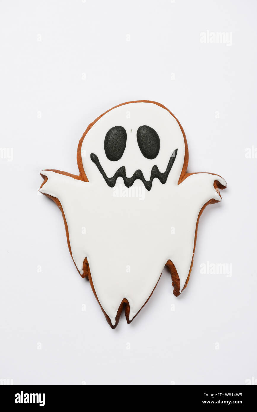 The hand-made eatable gingerbread Halloween ghost on white background ...