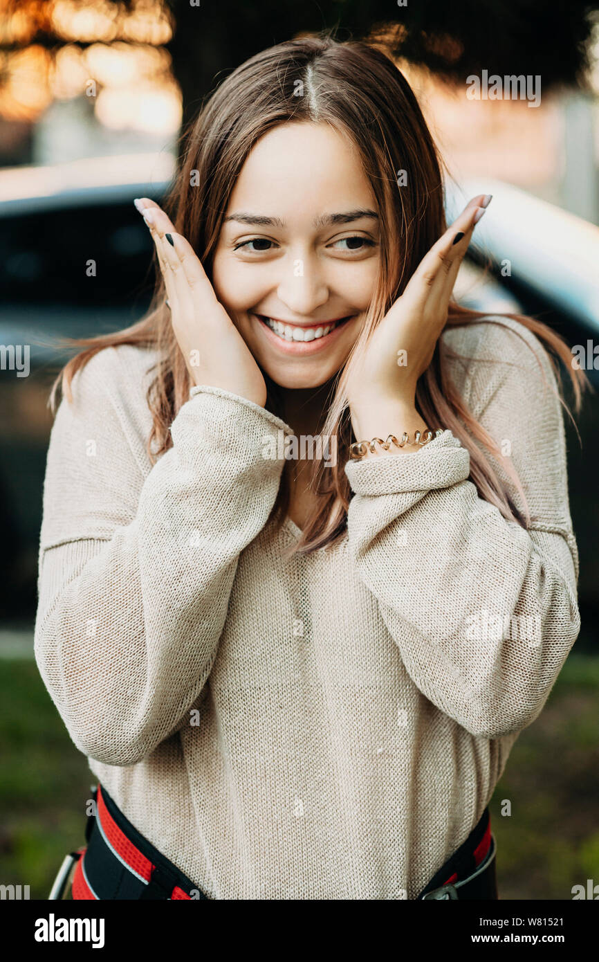 Close up portrait of a charismatic lovely female looking down laughing ...