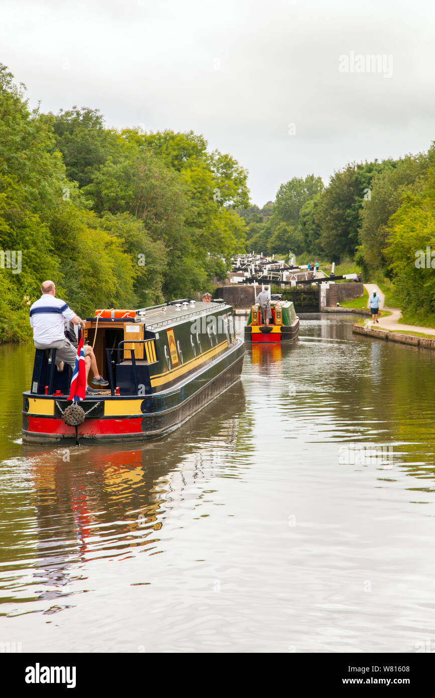 Canal narrow boat passing through Hatton locks on the Grand Union Canal ...