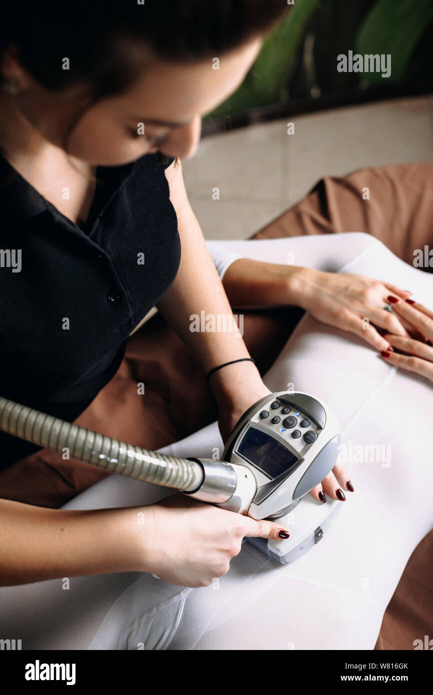 Upper view of a female hands doing anti age therapy with LPG for ...