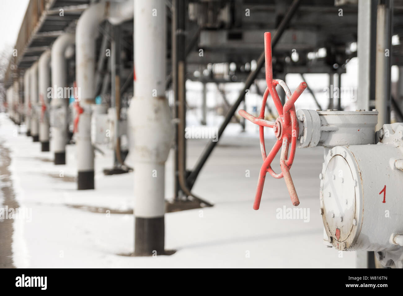 The grey metal tubes for gas delivering with red valves at gas ...