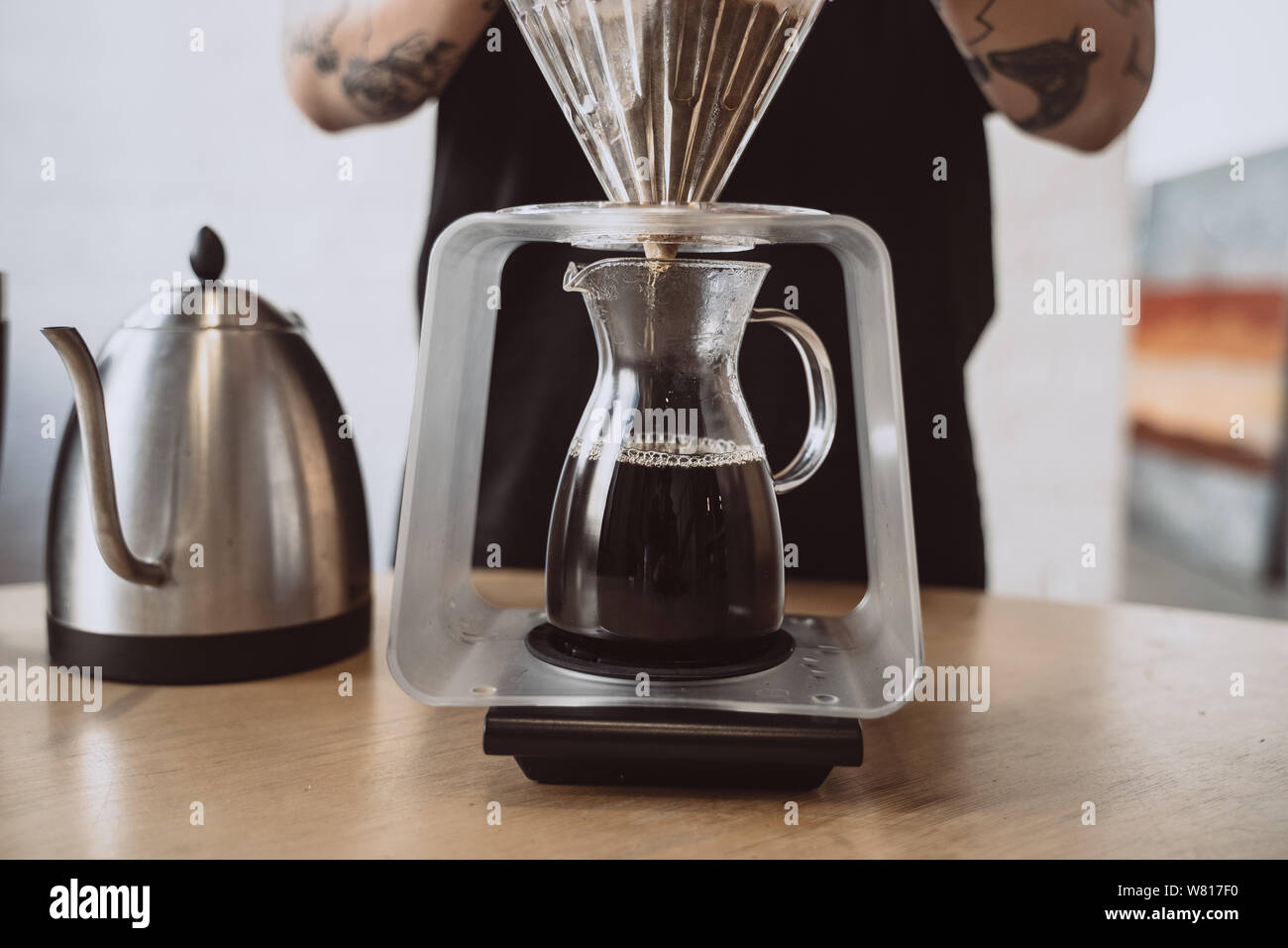 Close up of a barista making hand brewed coffee Stock Photo - Alamy