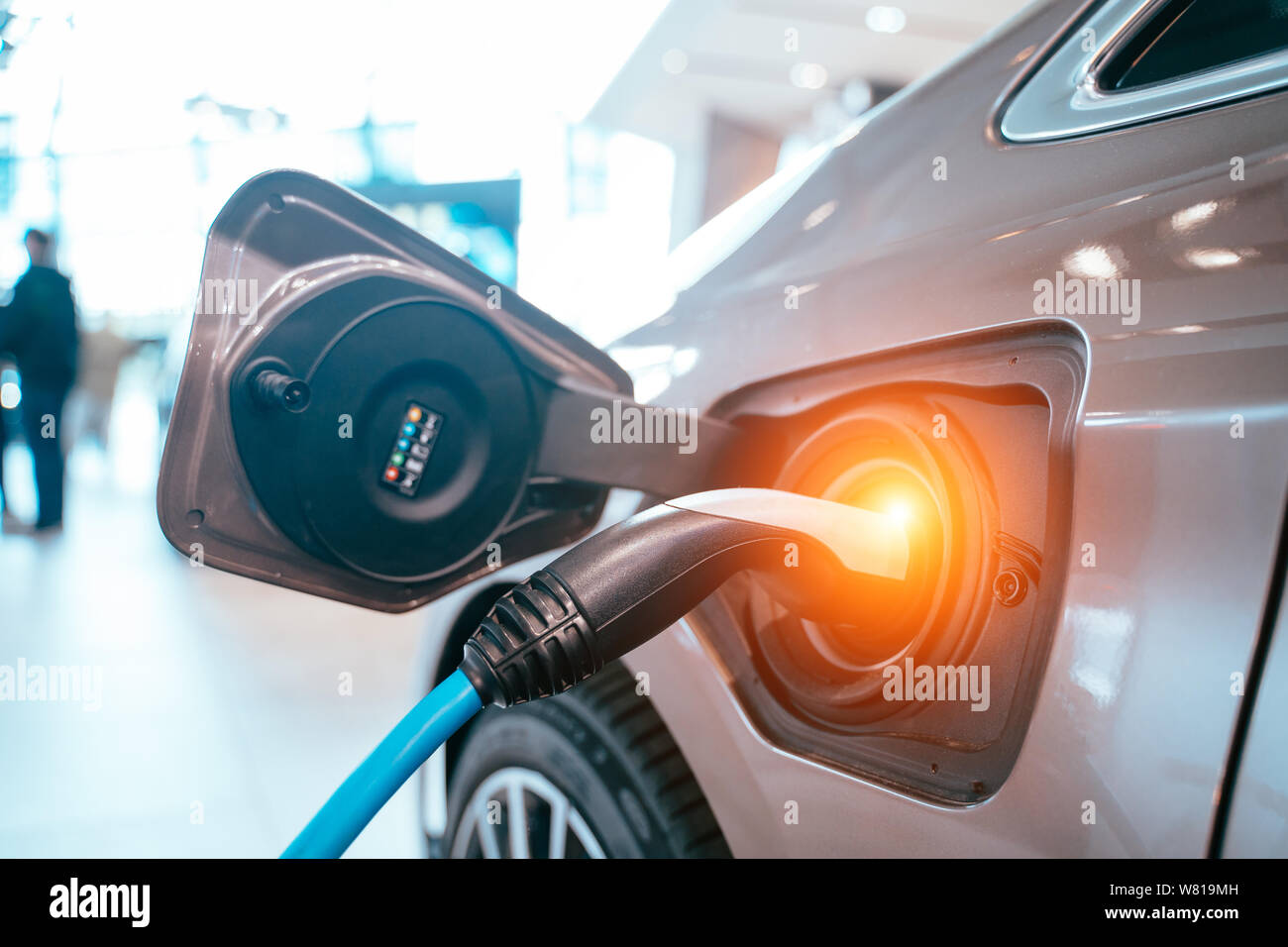 Power supply plugged into an electric car being charged Stock Photo - Alamy