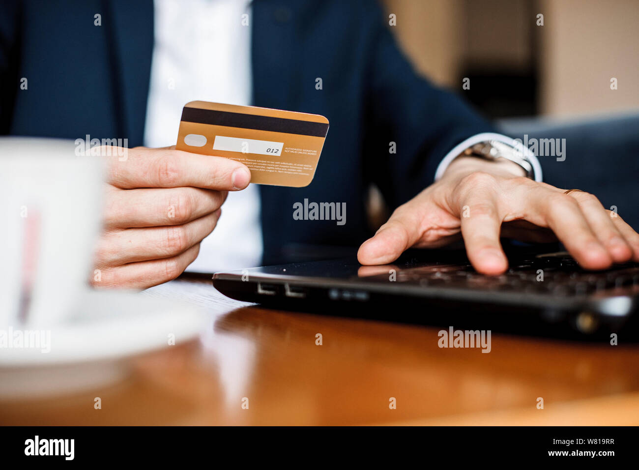 Close up photo of man's hands using credit card and purchasing ...