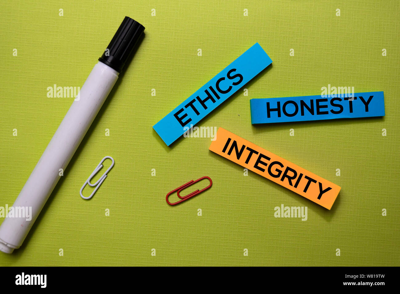 Ethics, Honesty, Integrity text on sticky notes isolated on green desk ...