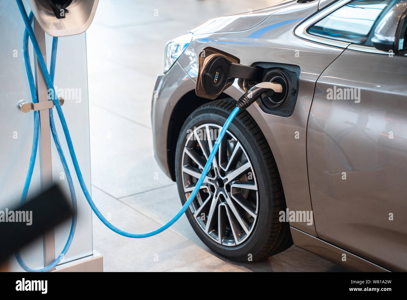 Power supply plugged into an electric car being charged Stock Photo - Alamy