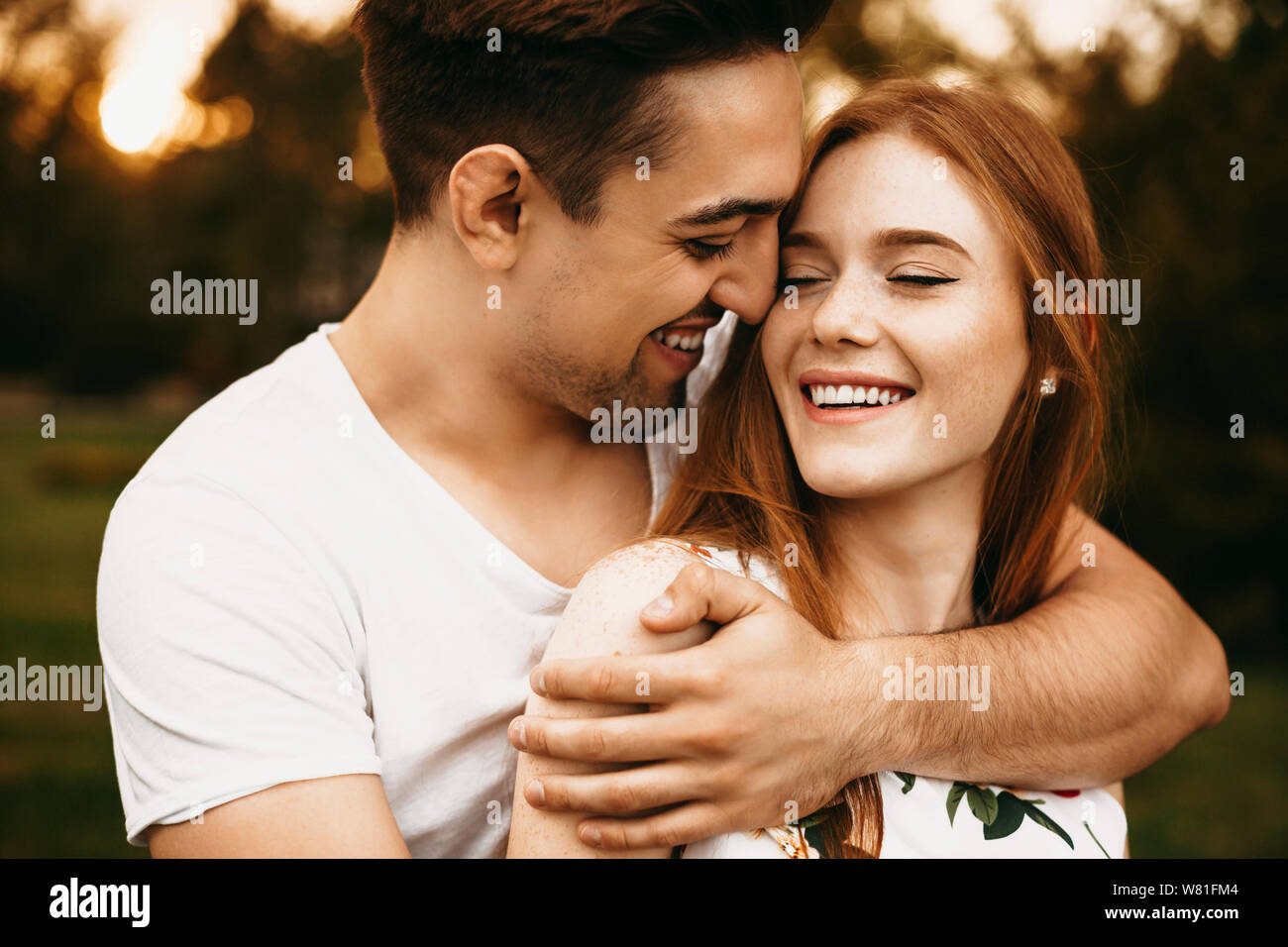 Portrait of a beautiful red hair woman with freckles smiling with eyes ...