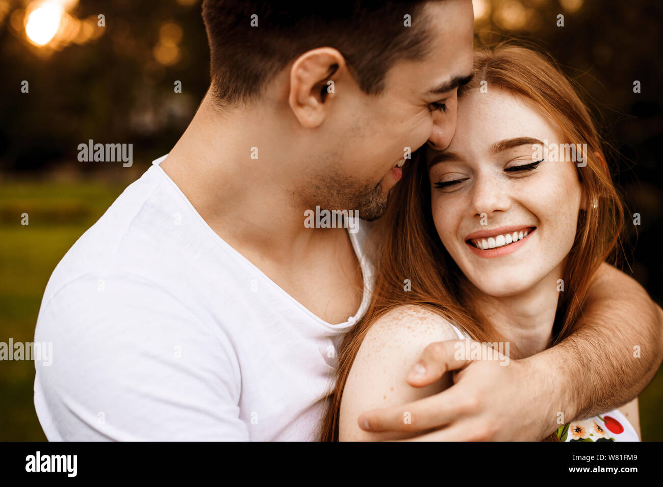 Amazing close up portrait of a cheerful caucasian red haired woman with freckles laughing with ...