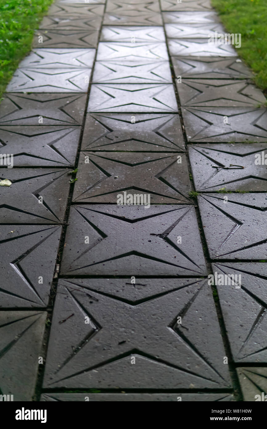 concrete tile walkway wet after rain Stock Photo - Alamy