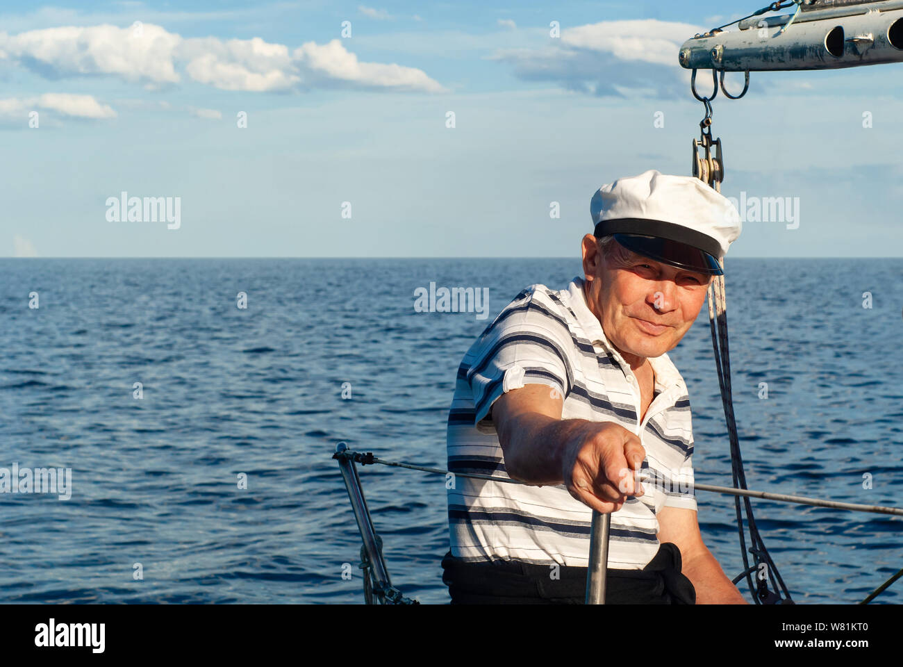 old sailor on his sailboat against a seascape Stock Photo - Alamy