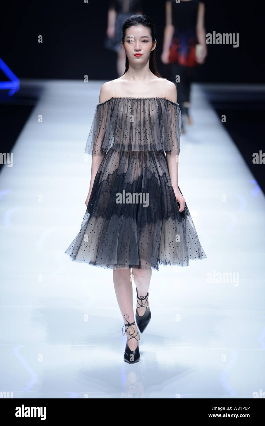 A model displays a new creation at the Asahi Kasei Chinese Fashion ...