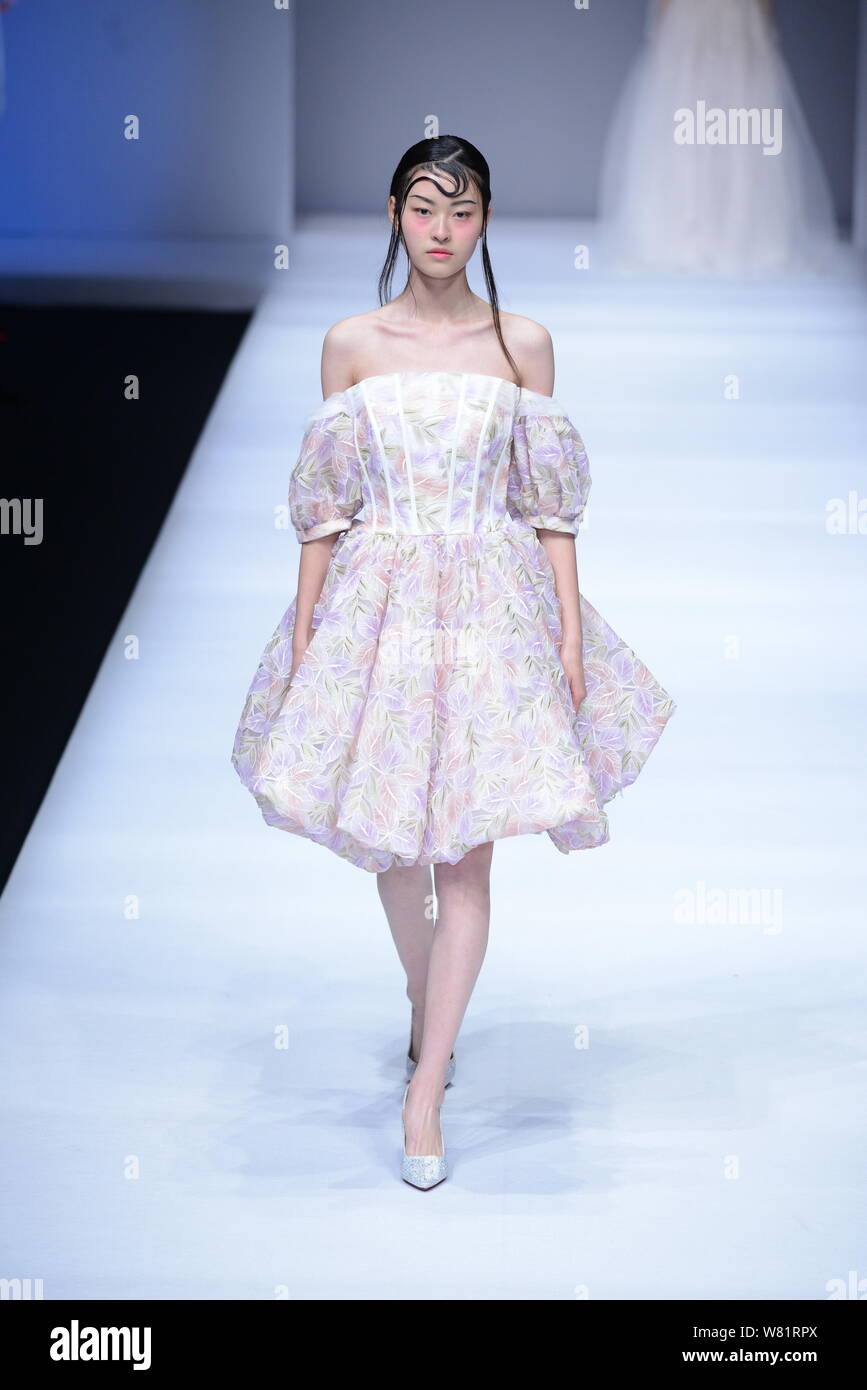 A model displays a new creation at the fashion show of Mija Design by ...