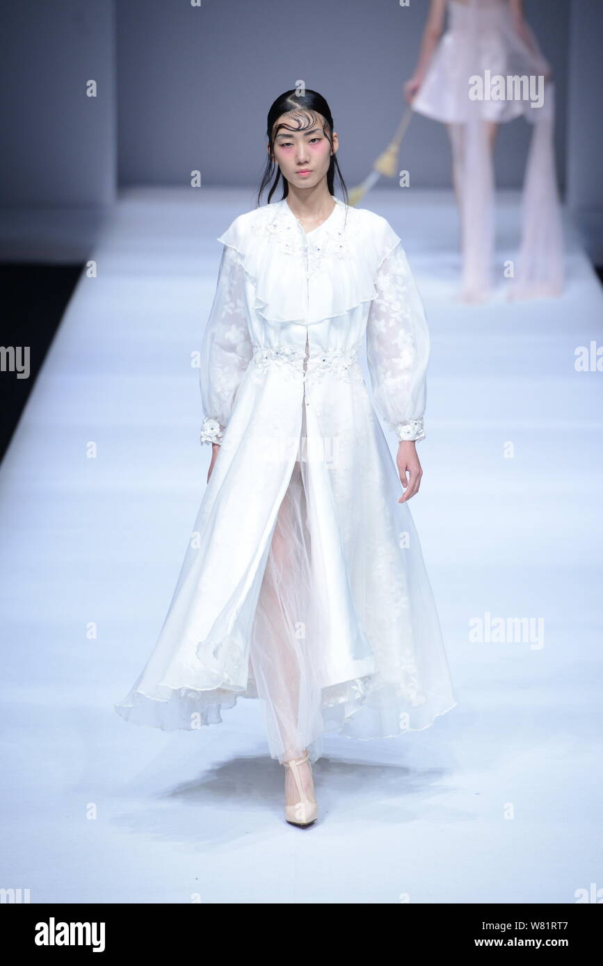 A model displays a new creation at the fashion show of Mija Design by ...