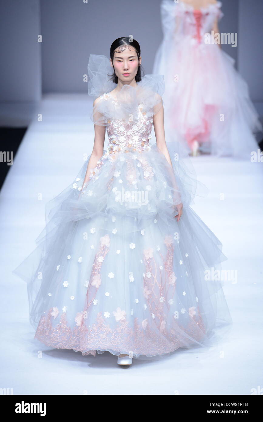 A model displays a new creation at the fashion show of Mija Design by ...