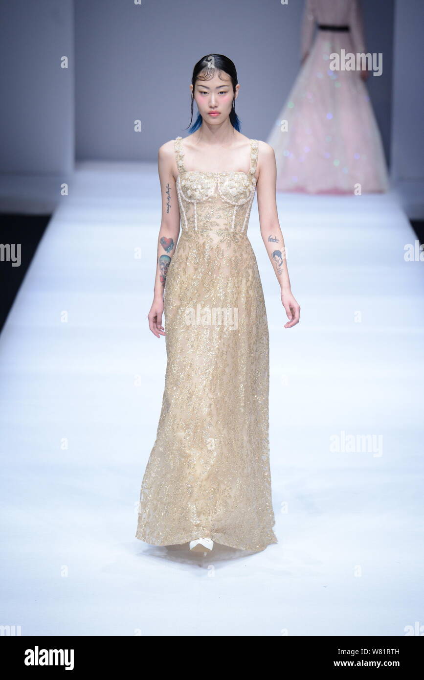A model displays a new creation at the fashion show of Mija Design by ...