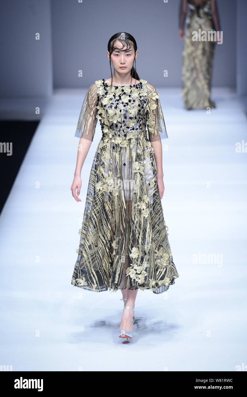 A model displays a new creation at the fashion show of Mija Design by ...