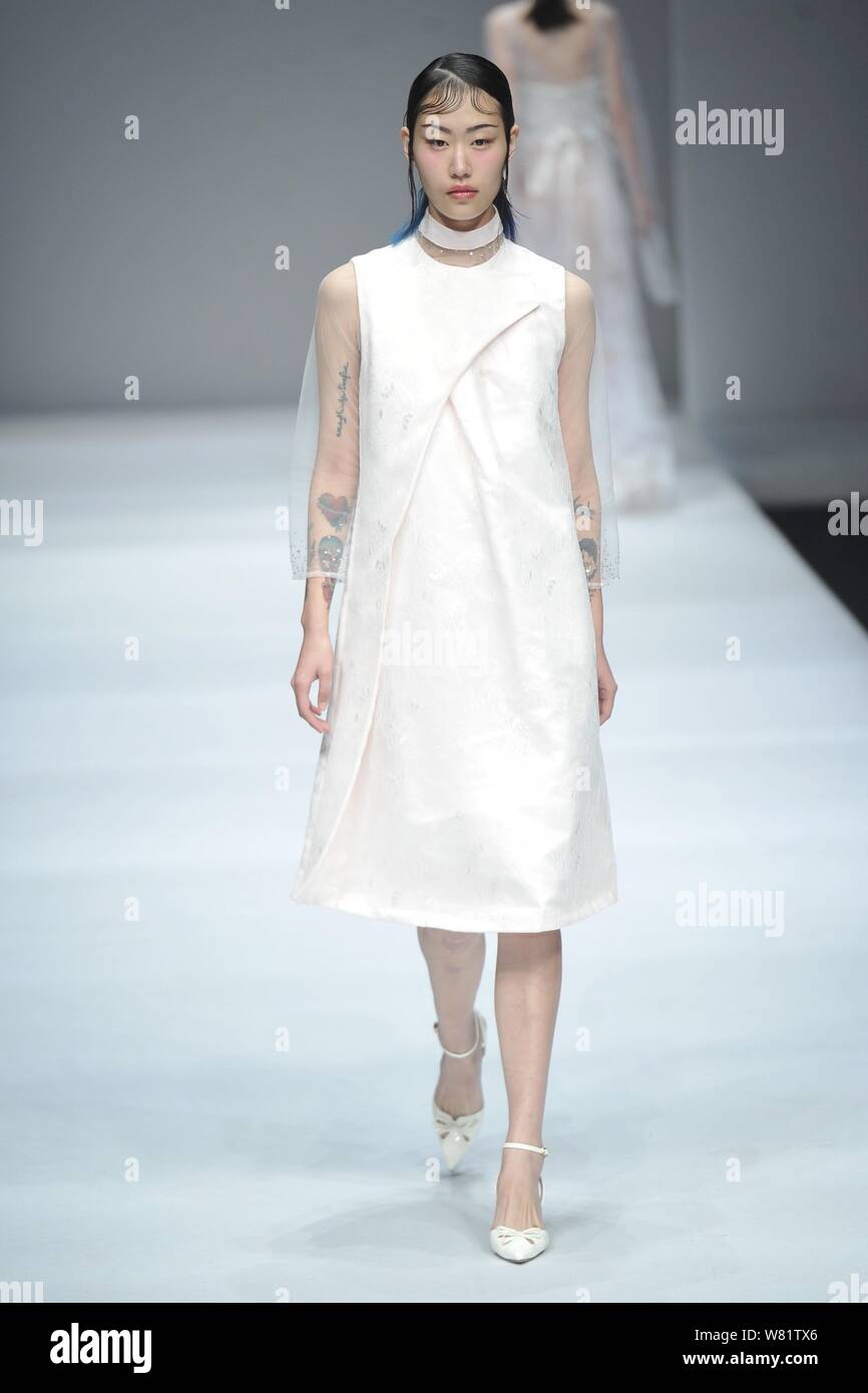 A model displays a new creation at the fashion show of Mija Design by ...