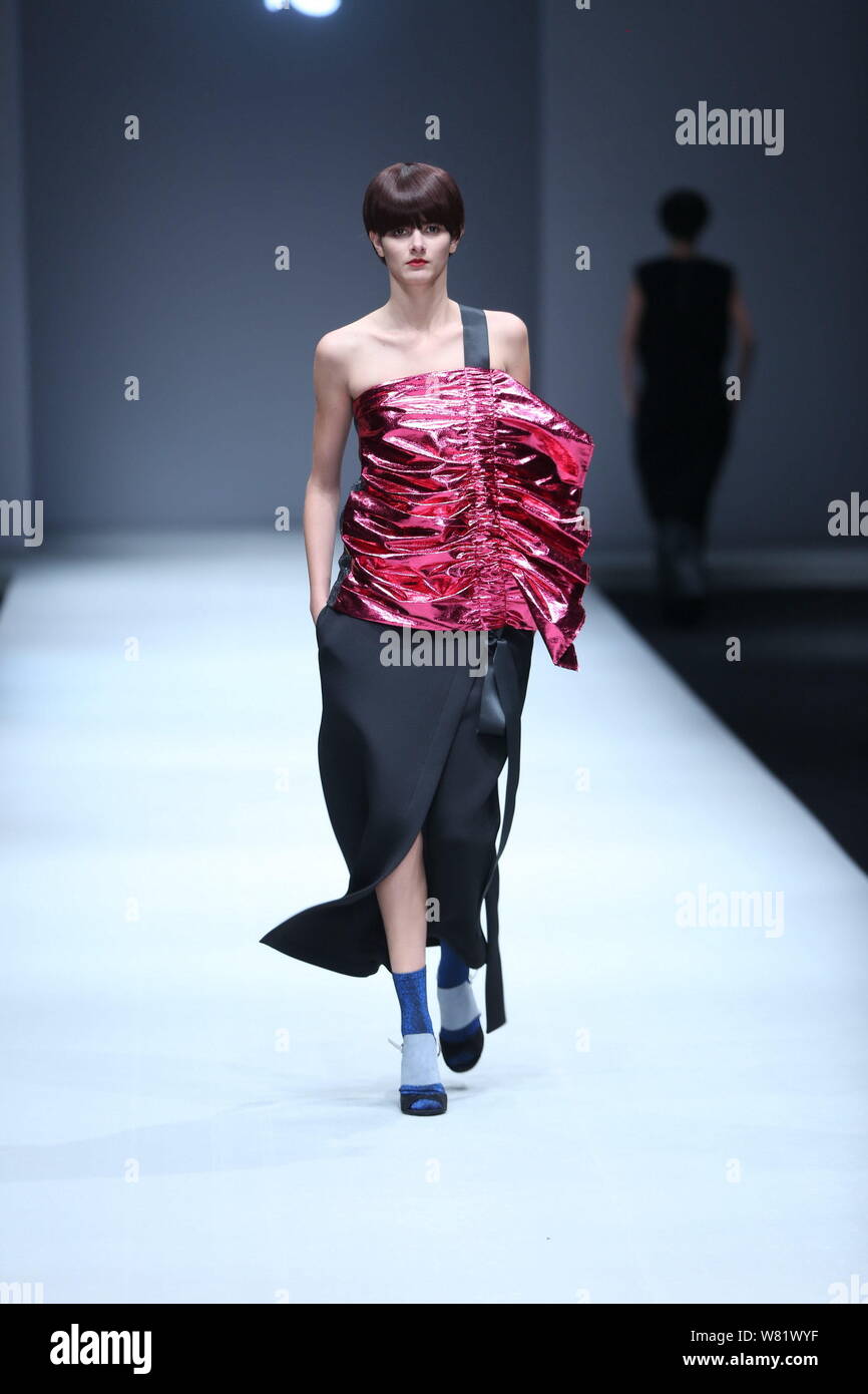 A model displays a new creation at the fashion show of ZIJUE by Chinese ...