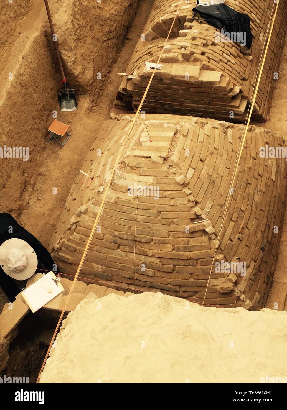 A Chinese archaeologist investigates a tomb in the shape of a pyramid ...