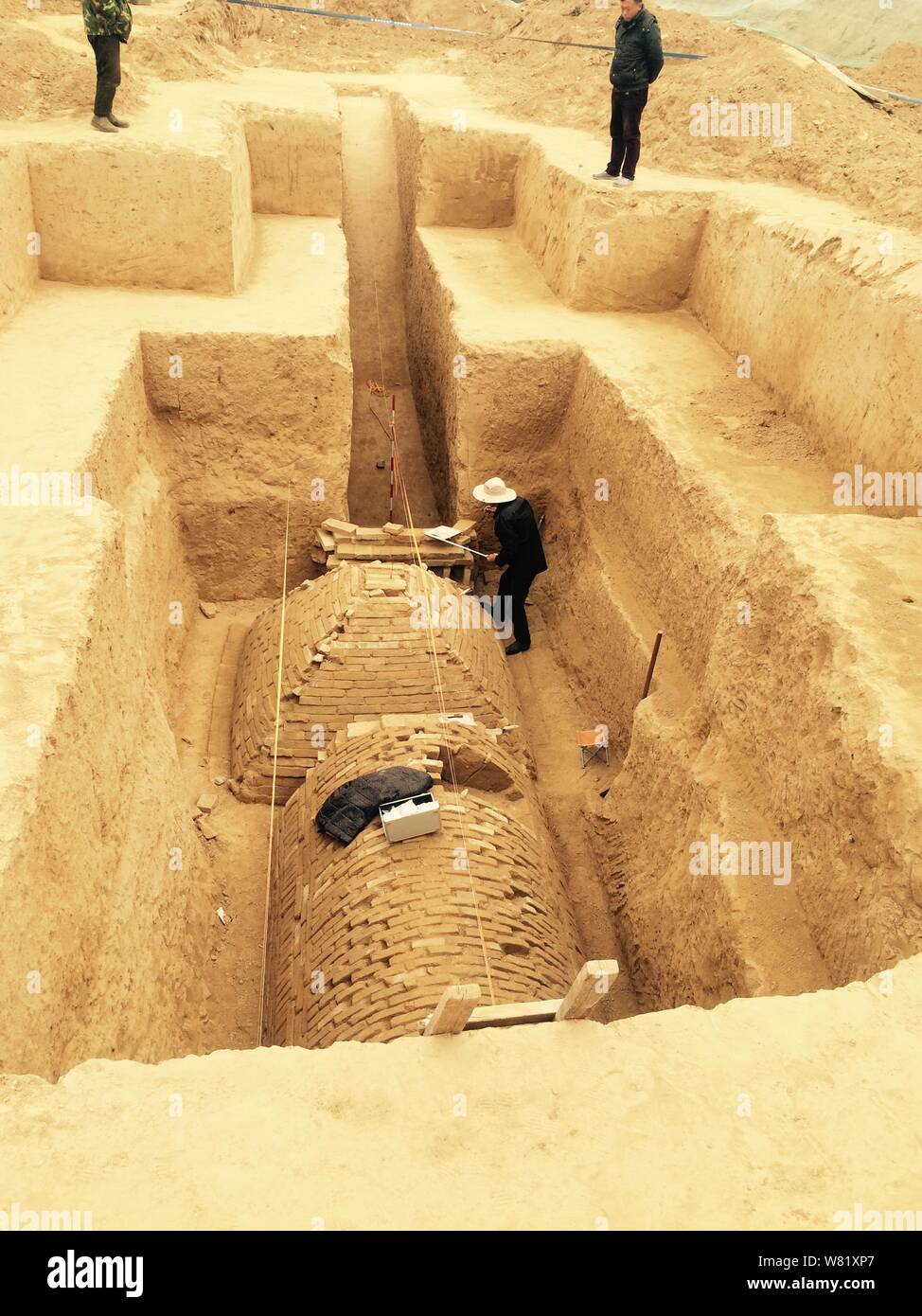 A Chinese archaeologist investigates a tomb in the shape of a pyramid ...