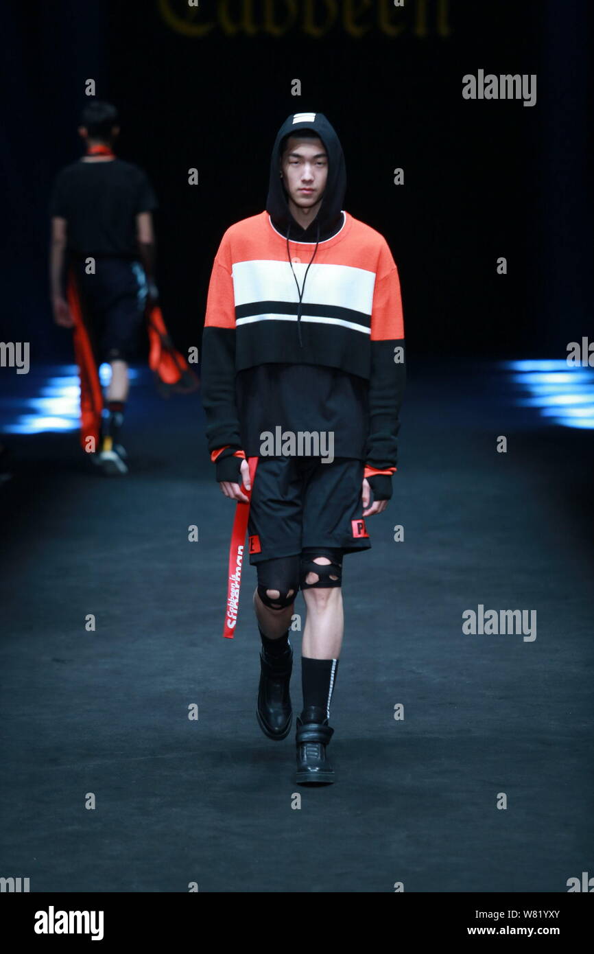 Chinese fencer Dong Li displays a new creation at the fashion show of ...