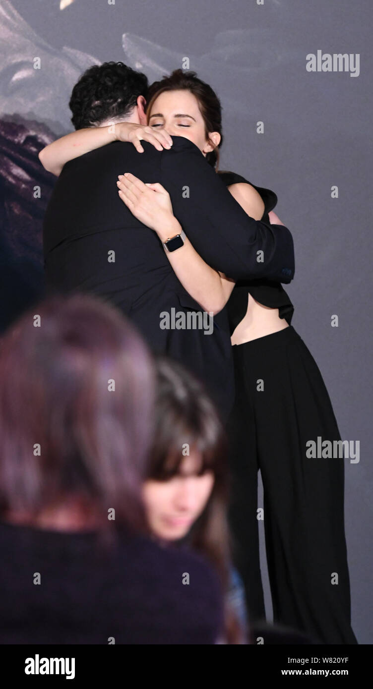 British actress Emma Watson hugs American actor Josh Gad at a press ...