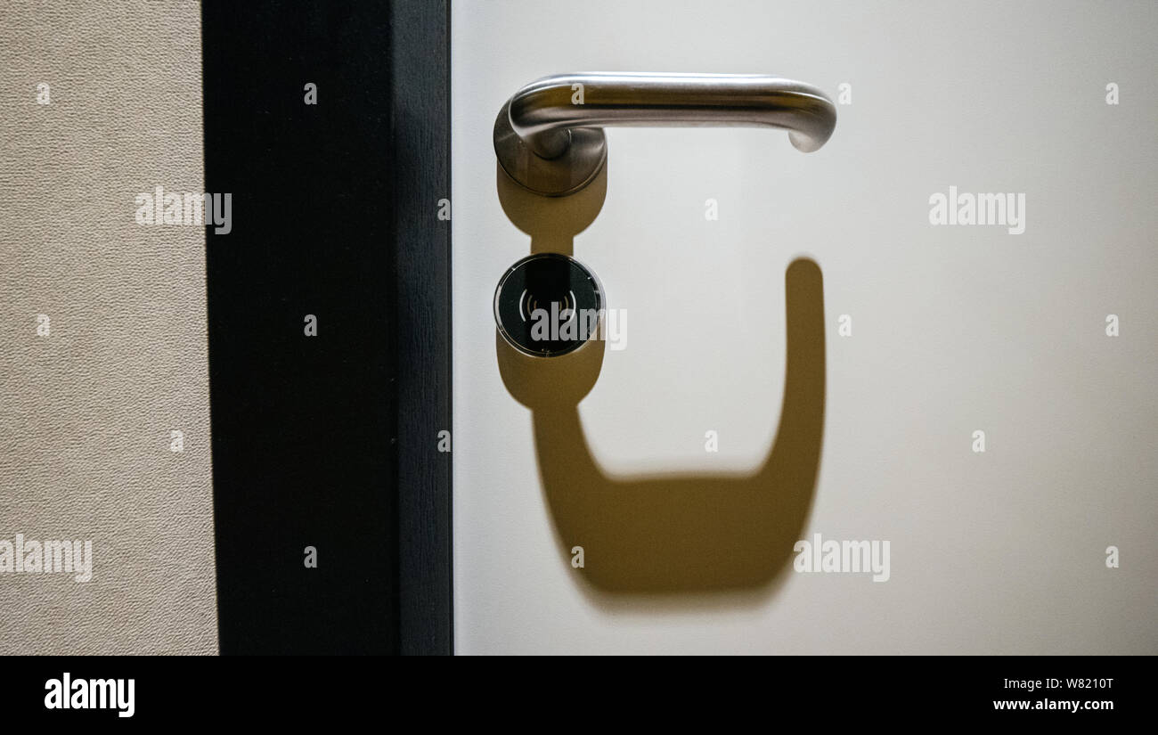 Metallic door handle with wireless RFID key opeper in modern hotel ...
