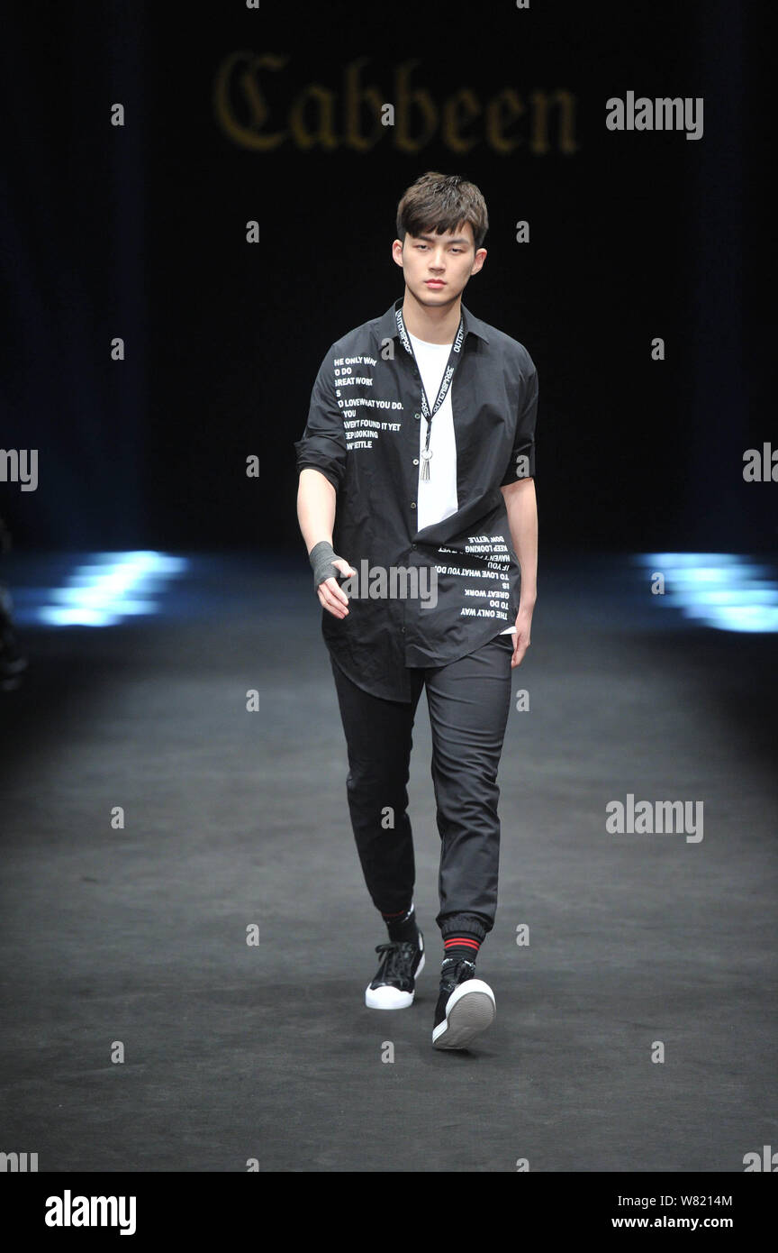 Chinese fencer Dong Li displays a new creation at the fashion show of ...