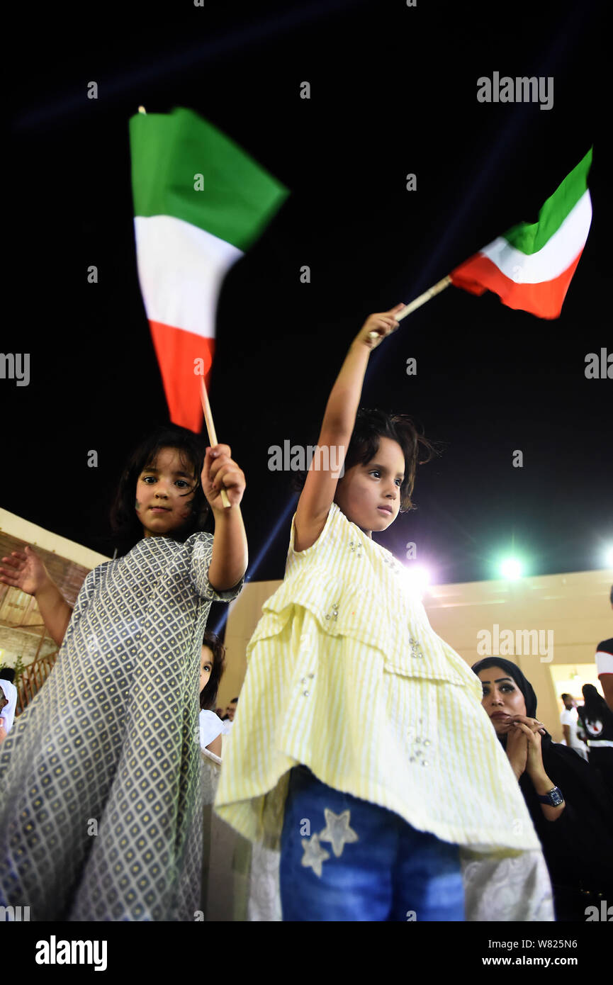 Kuwait City, Kuwait. 7th Aug, 2019. Girls wave Kuwait flags during an ...