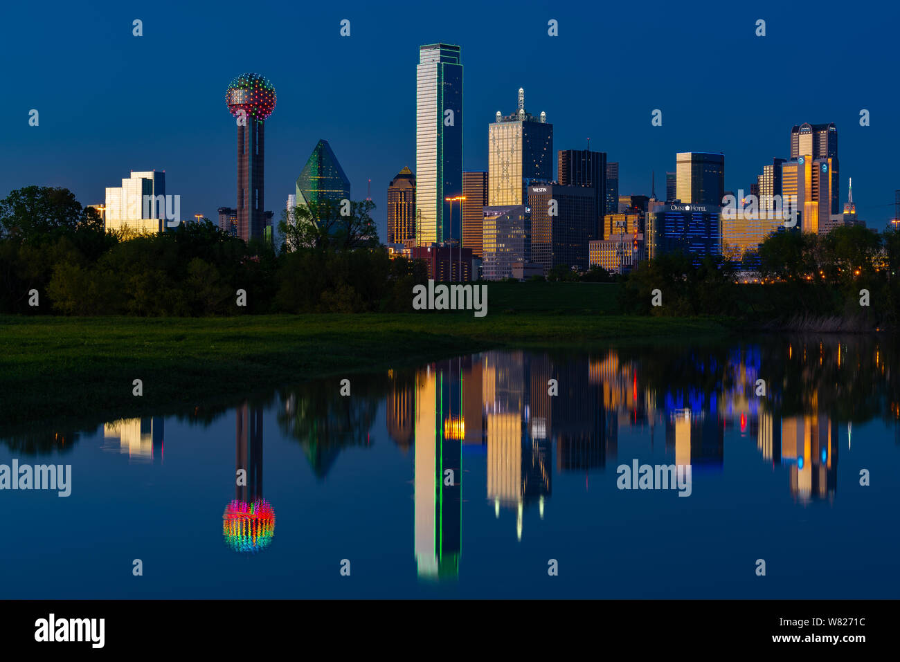 Beautiful night cityscape view of downtown Dallas, Texas reflecting off ...